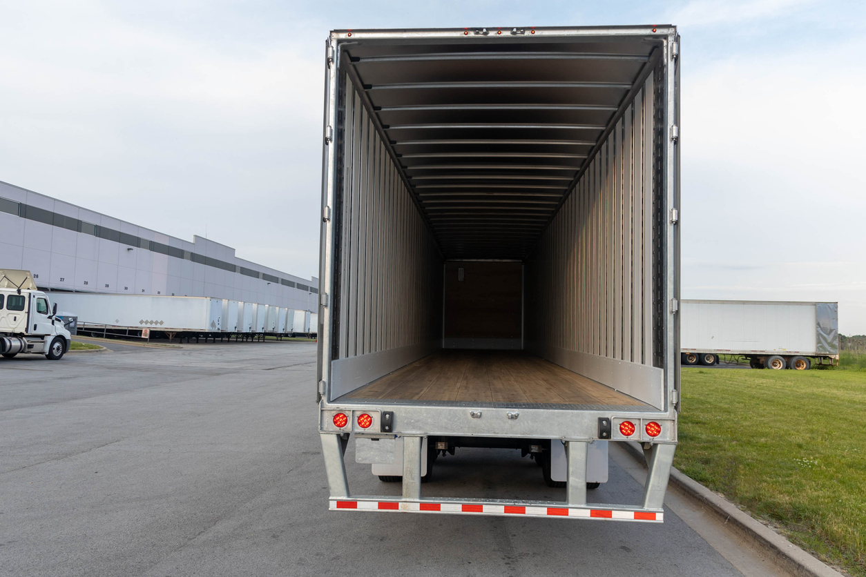Empty semi-truck trailer in warehouse - Truck News